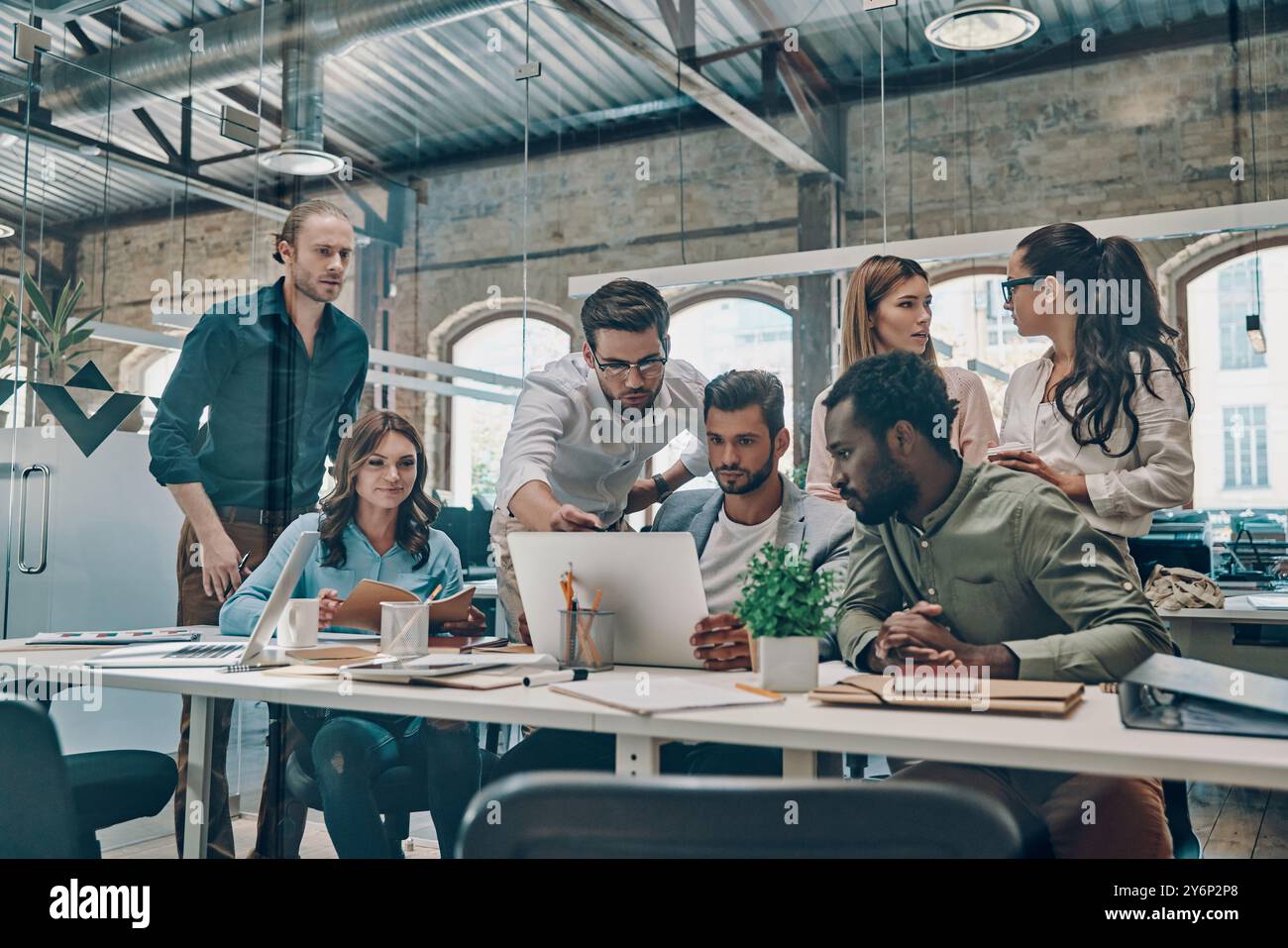 Group of young modern people in smart casual wear communicating and ...