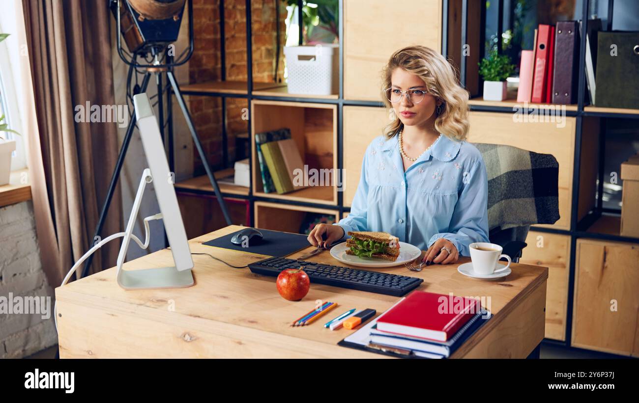 Office worker multitasks eating hi-res stock photography and images - Alamy