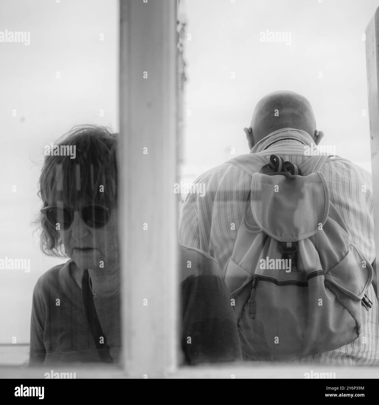 Black and white image of two people looking in opposite directions ...