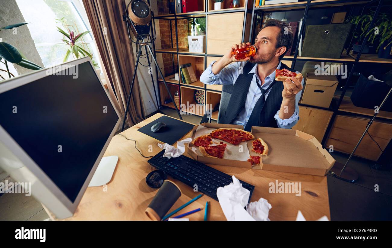 Man takes drink from bottle, holding his pizza slice, combining bad ...