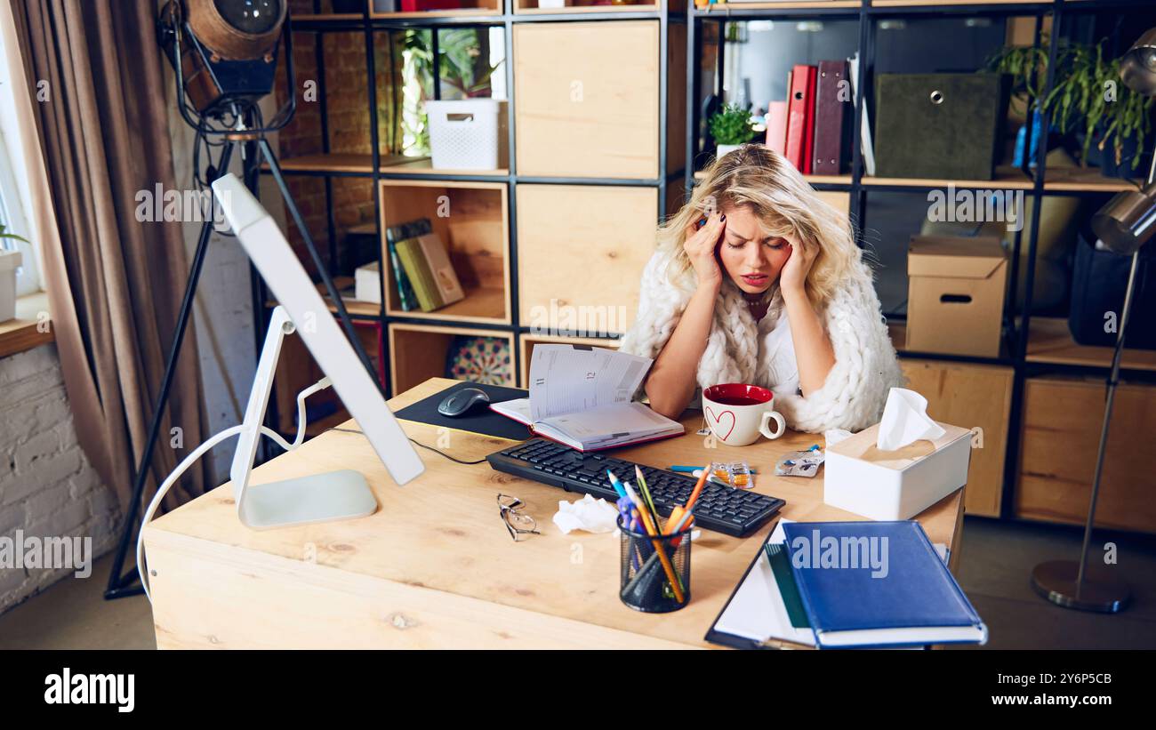 Employee struggles with fever, thermometer in hand, while still ...