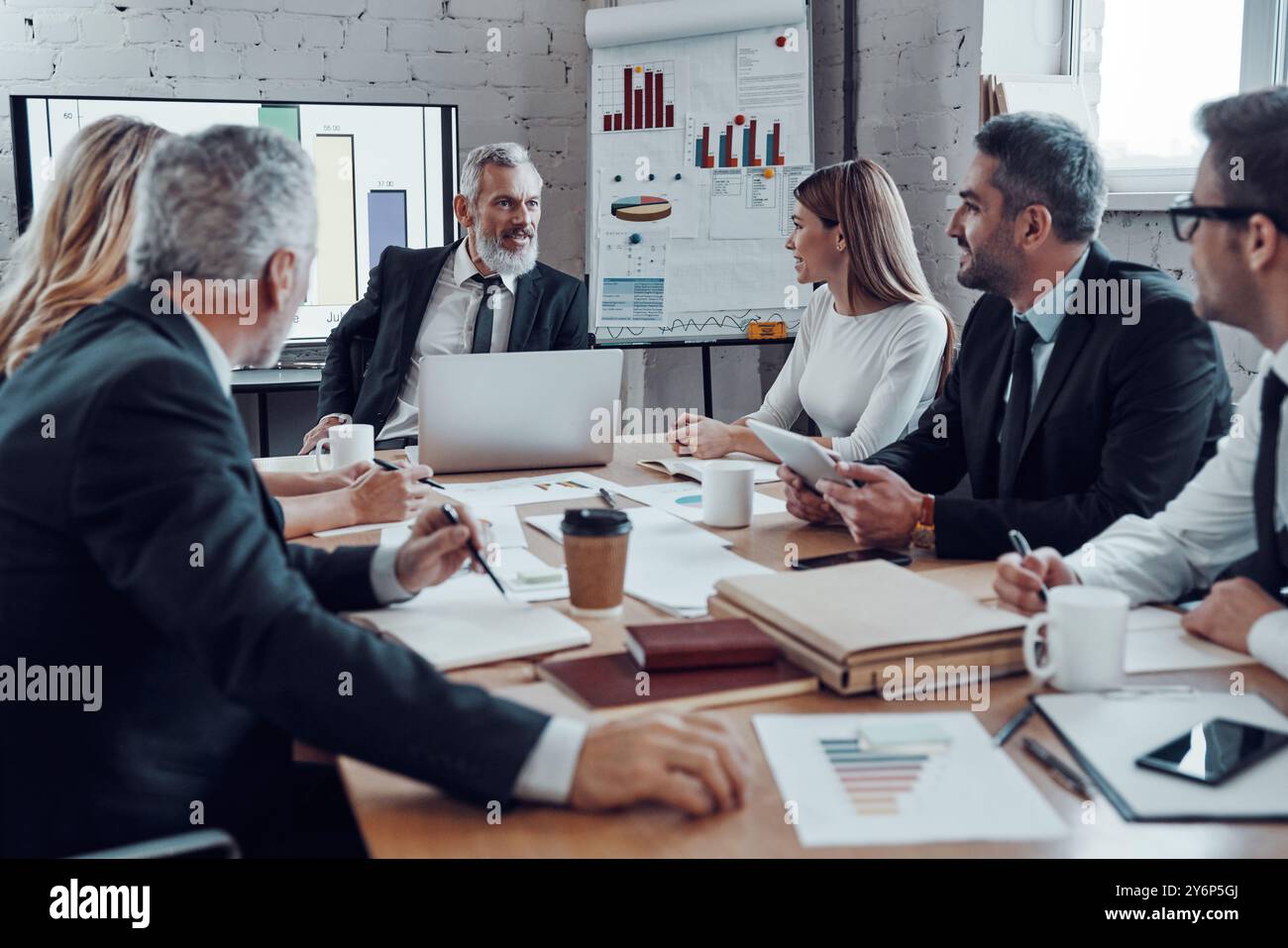 Modern business people communicating with each other while working ...