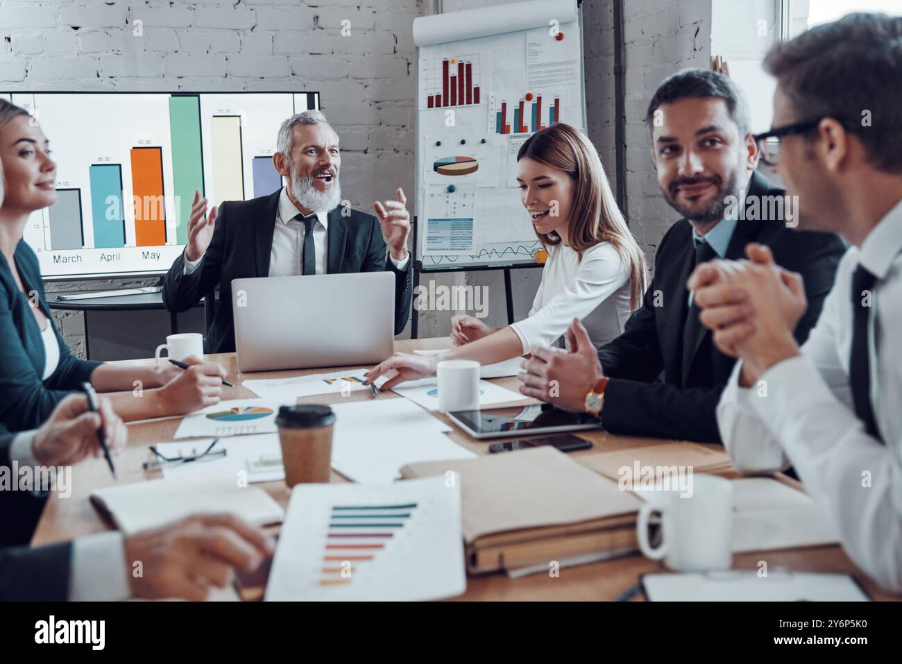 Modern business people communicating with each other while working ...