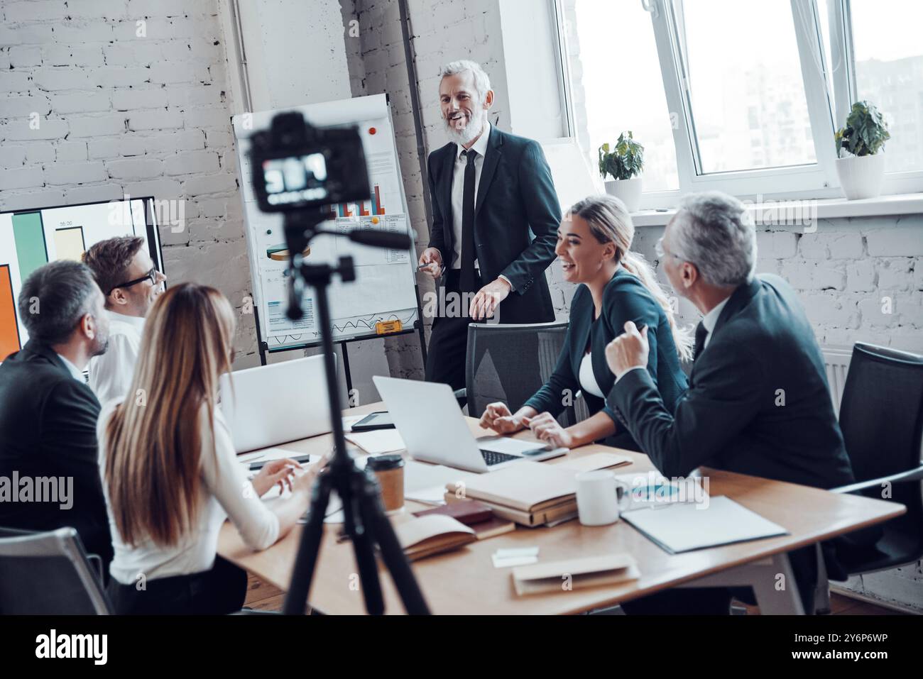 Successful business team listen a man which conducting presentation ...