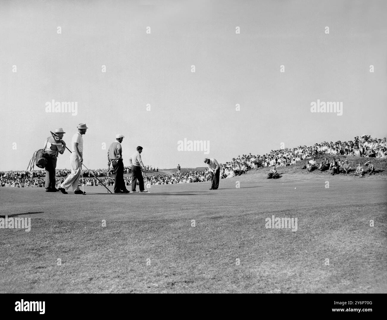 Sam Snead of the USA sinks the final putt watched by Kel Nagle, Arnold ...