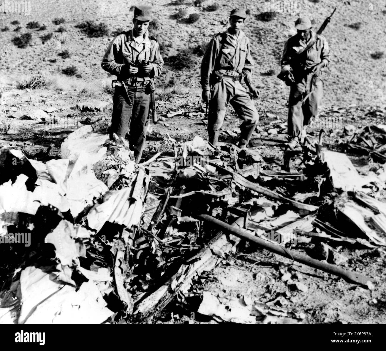 Algerian soldiers inspecting the wreckage of a French bomber plane brought down by machine gun ...