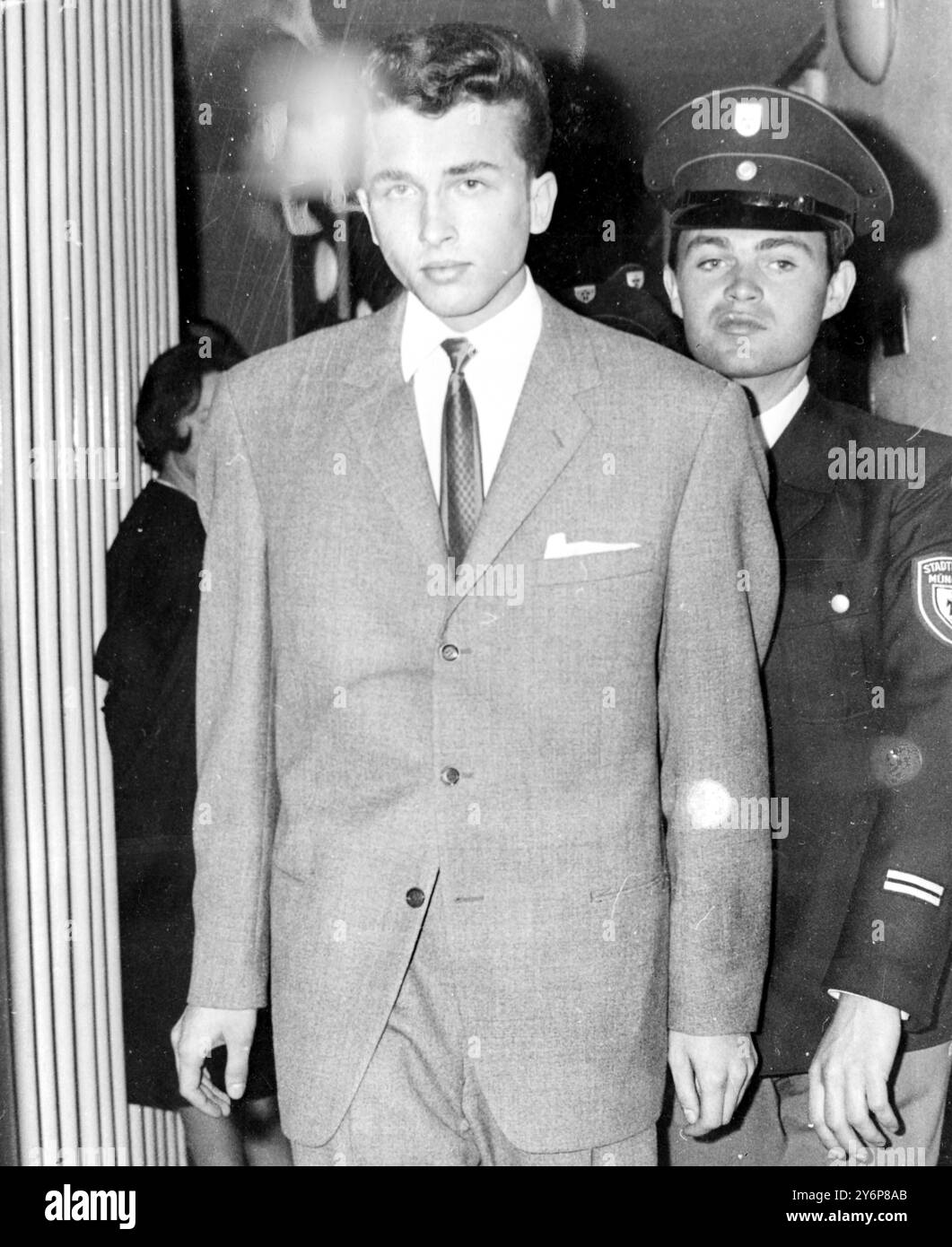 Eighteen year old Michael Thiess is led into a juvenile court to go on ...