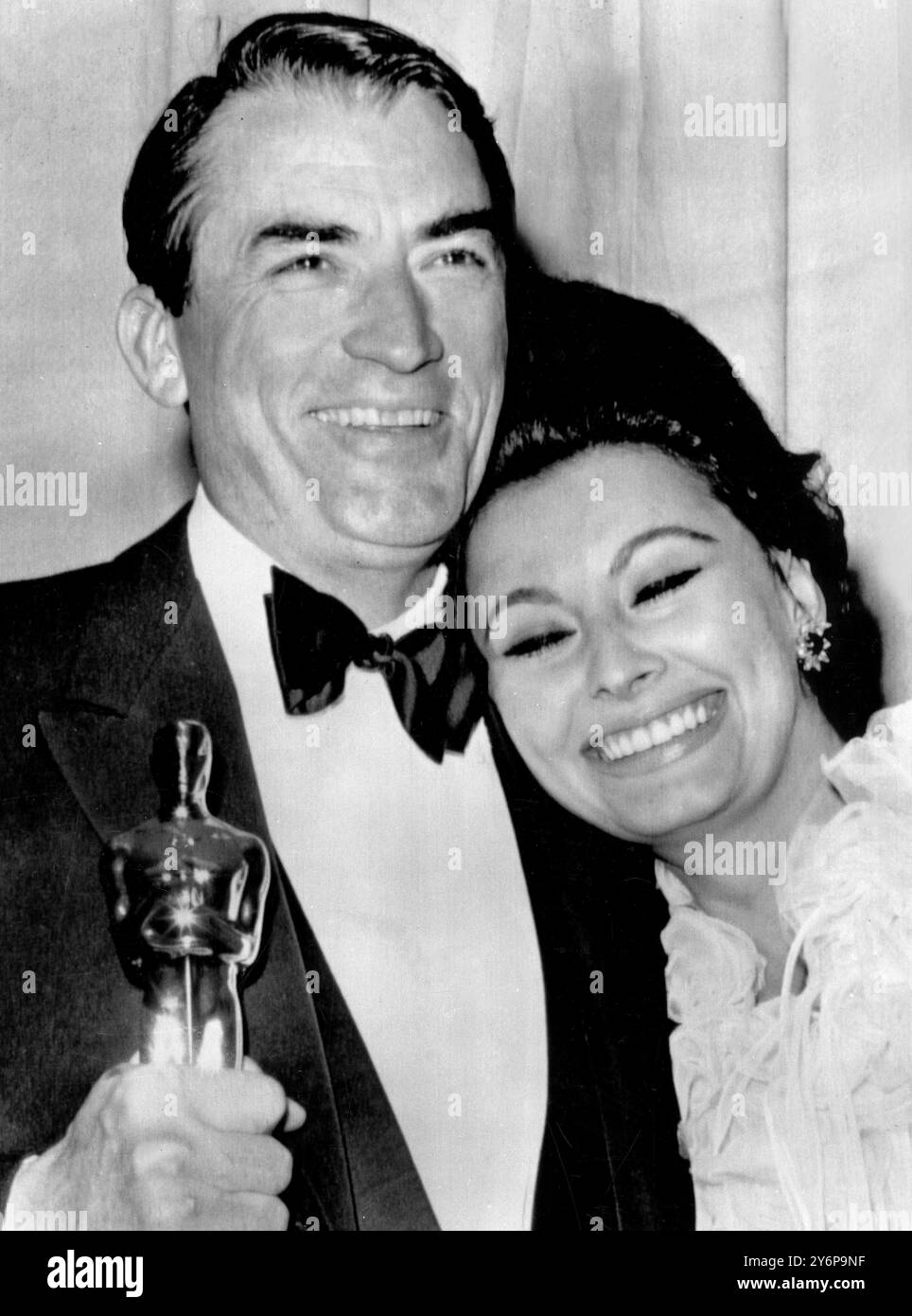Italian actress Sophia Loren embraces Gregory Peck after presenting him ...