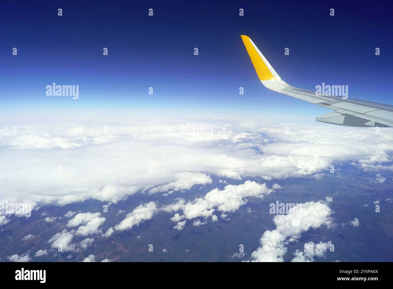 Flying above the clouds: sky and airplane wing photographed from the ...