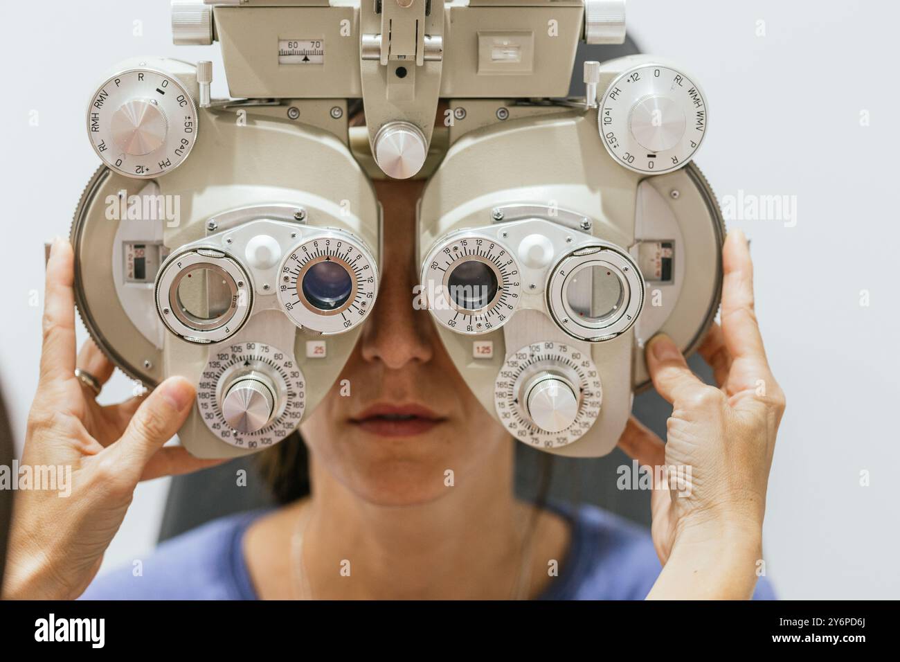 Optometrist adjusting trial frame for eye examination Stock Photo - Alamy