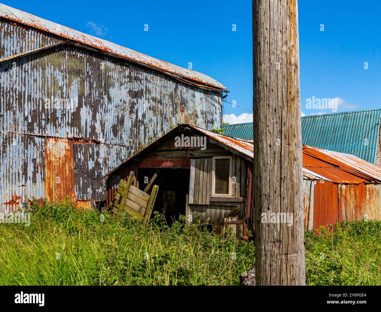 Detail of a corrugated iron wall on a metal building with signs of rust ...