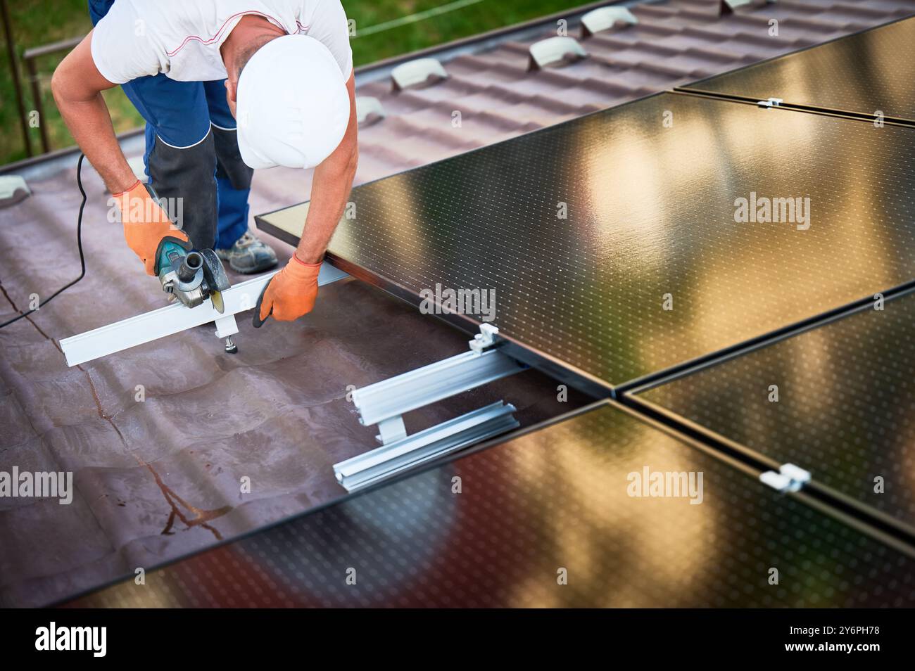 Worker installing or maintaining photovoltaic solar panel system on ...