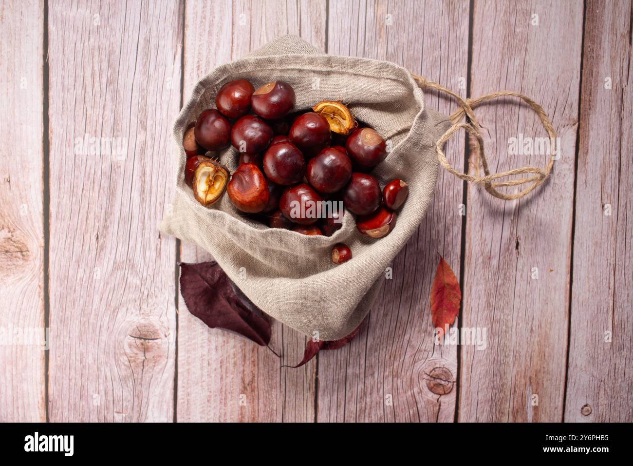 Fresh chestnuts in linen bag on the wood background Stock Photo - Alamy