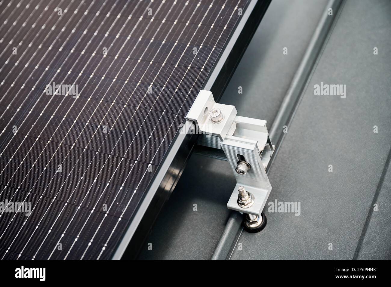Close up of solar panel, securely fastened with robust mounting clamp ...