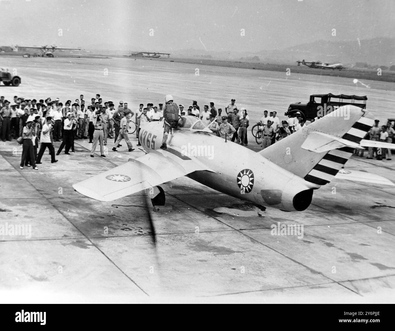 CHANG HSIEN CHIN CLIMBS INTO COCKPITIN TAIPEI / ; 20 AUGUST 1962 Stock ...