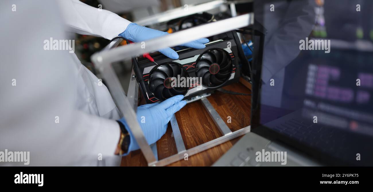 Man mechanic installing cooler fan with copper tubes on computer ...