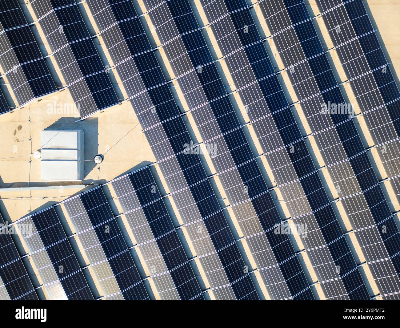 Aerial view of a large solar panel installation on a commercial rooftop ...