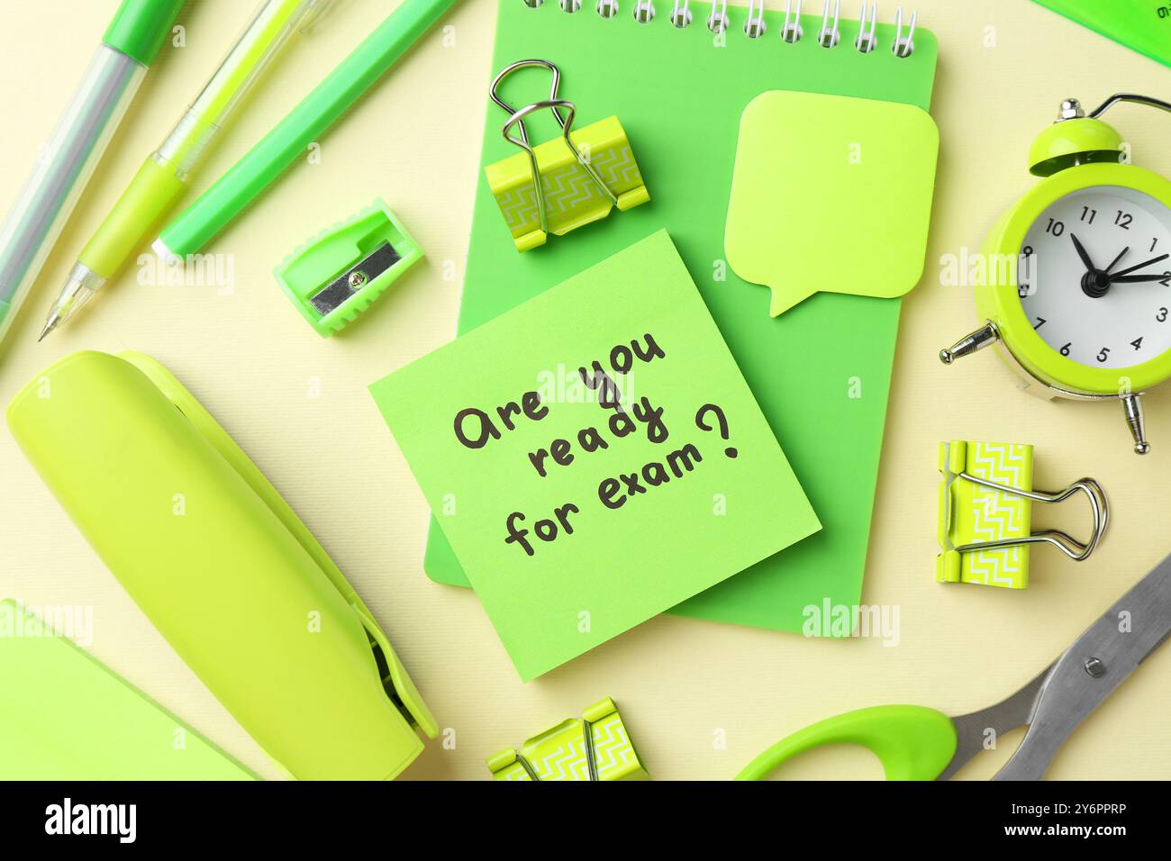 Paper note with question Are You Ready For Exam and stationery on pale ...