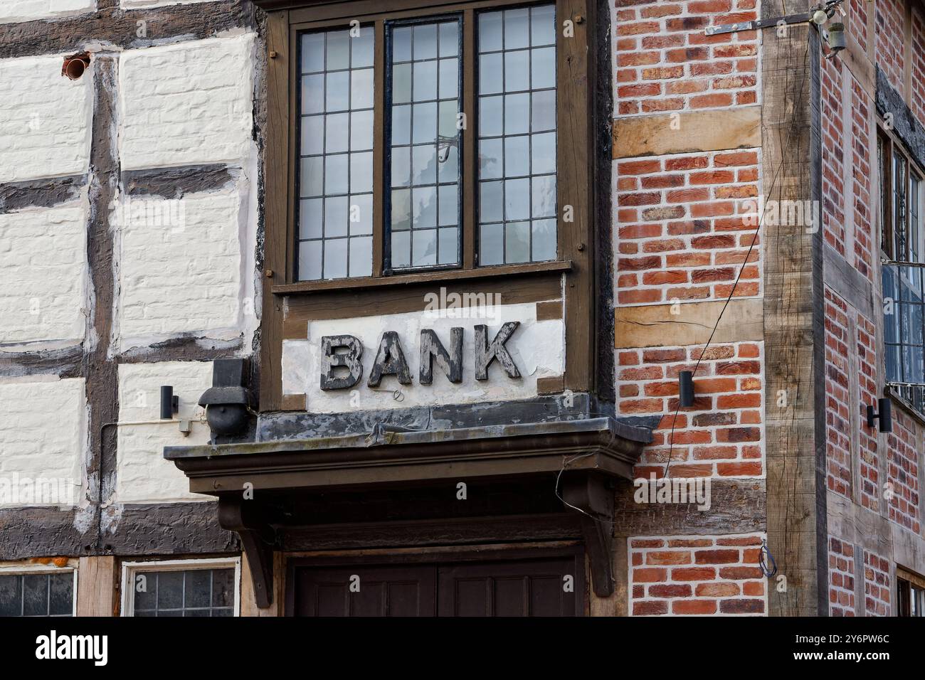 A Bank sign above a door that no longer is a bank. A closed bank branch ...