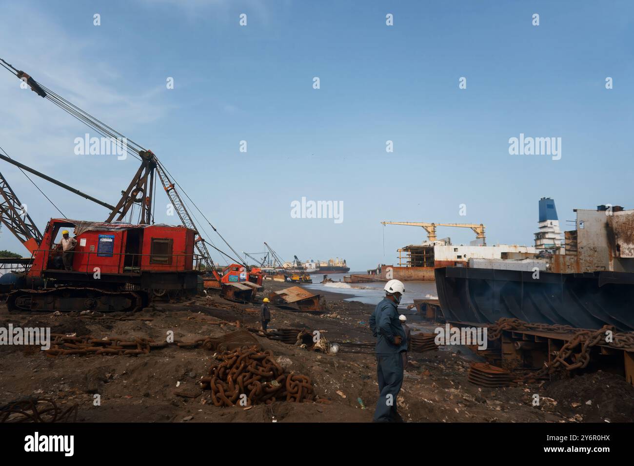 Portray the intense industrial activity at Alang Shipyard, where ...
