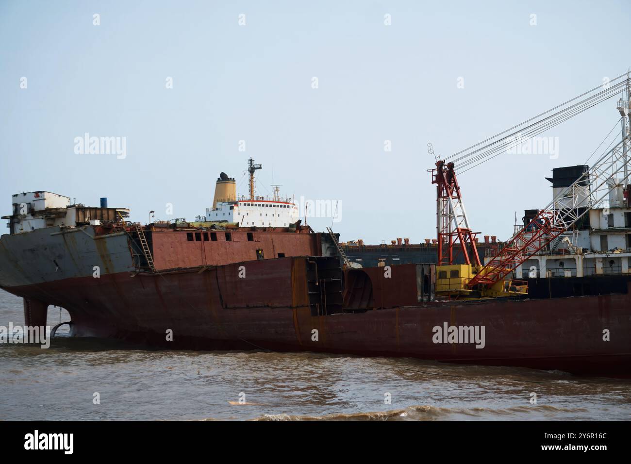 At Alang Shipyard, a significant ship is being hoisted by a crane ...