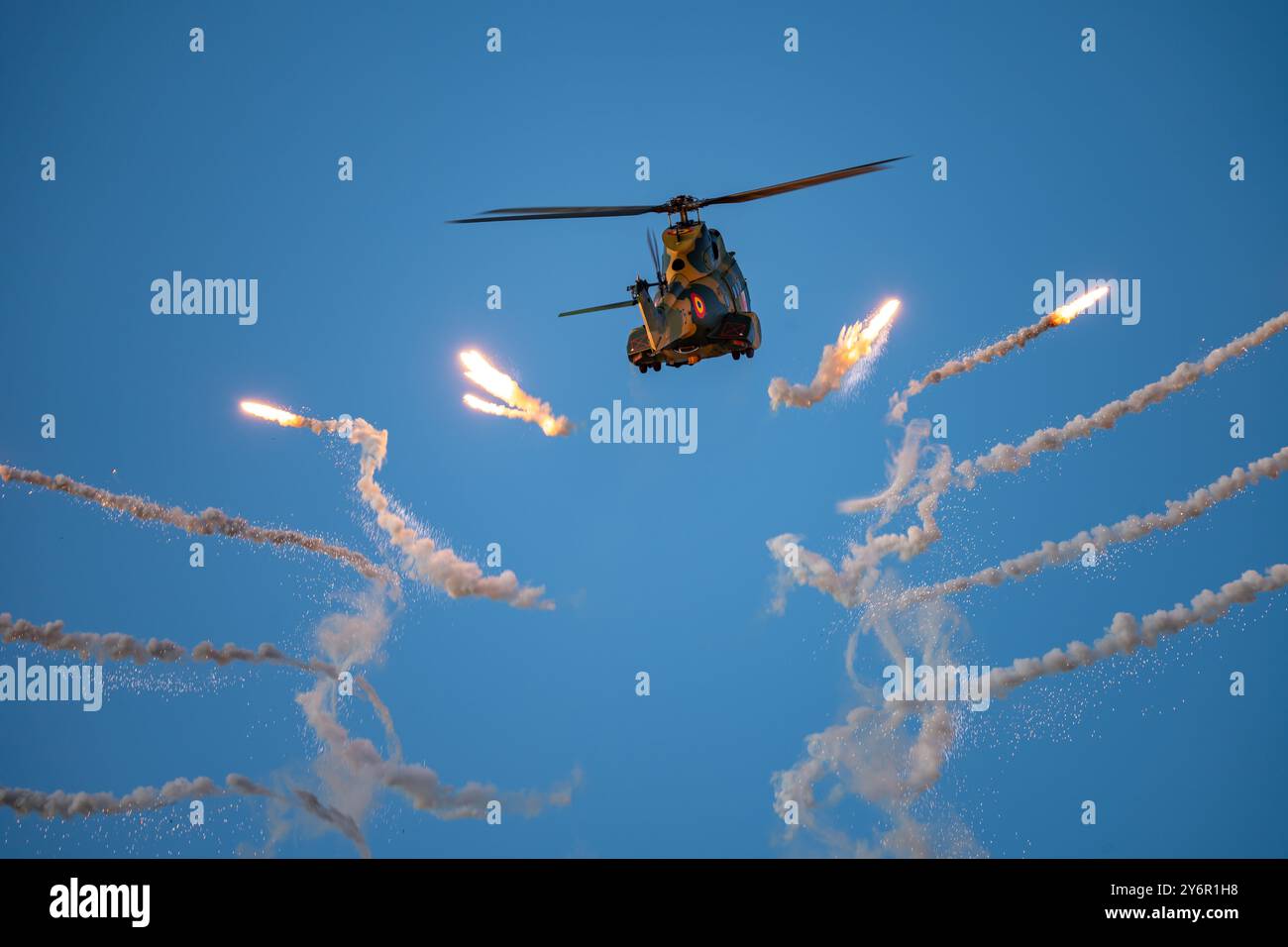 A military helicopter releasing flares during an aerial display against ...