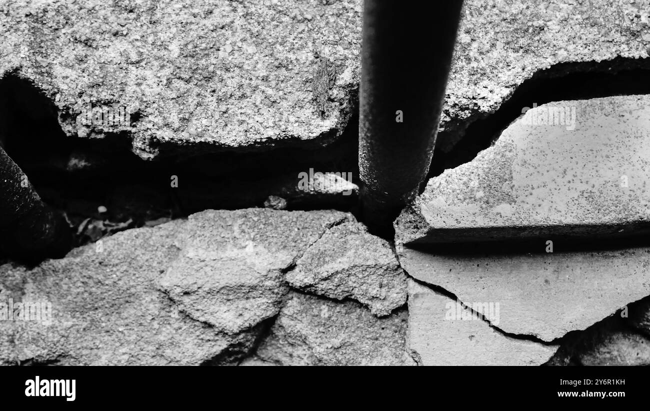 Abstract image of an old wall, broken plaster around aged iron grill ...