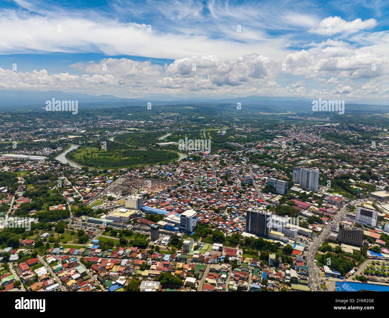 Beautiful blue sky and clouds above in Davao City. Eagle aerial view of River and cityscape of ...