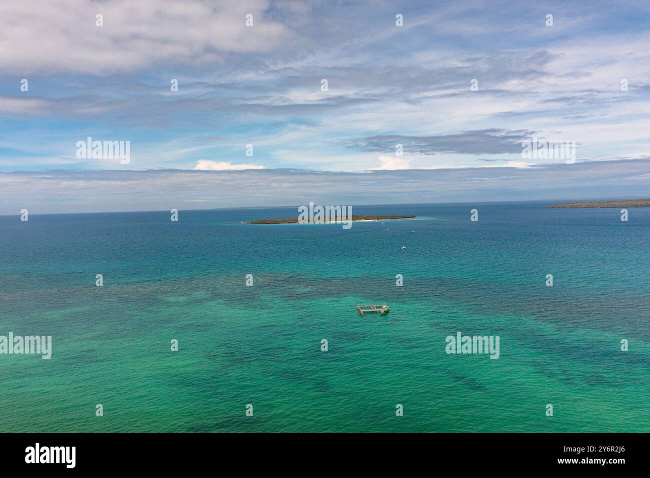 Turquoise sea water with coral reefs and tourist boat. Tropical island ...