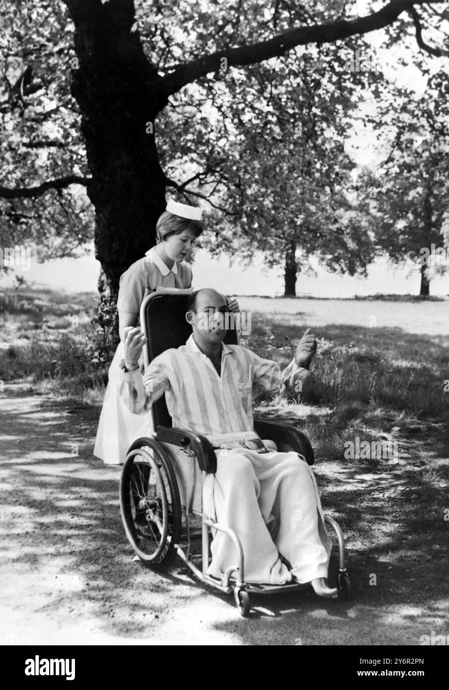 9 JUNE 1962 BRITISH RACING DRIVER STIRLING MOSS BEING WHEELED BY A ...
