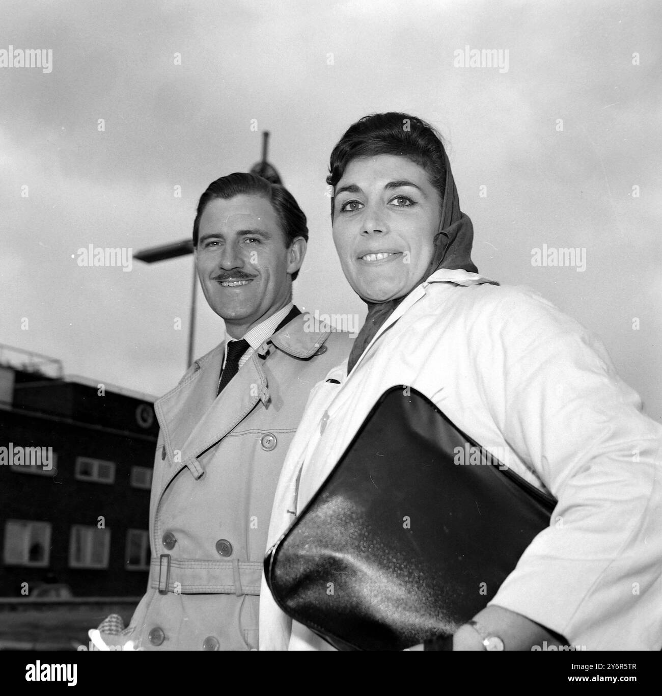 RACING DRIVER GRAHAM HILL WITH WIFE AT LONDON AIRPORT / ; 21 MAY 1962 ...