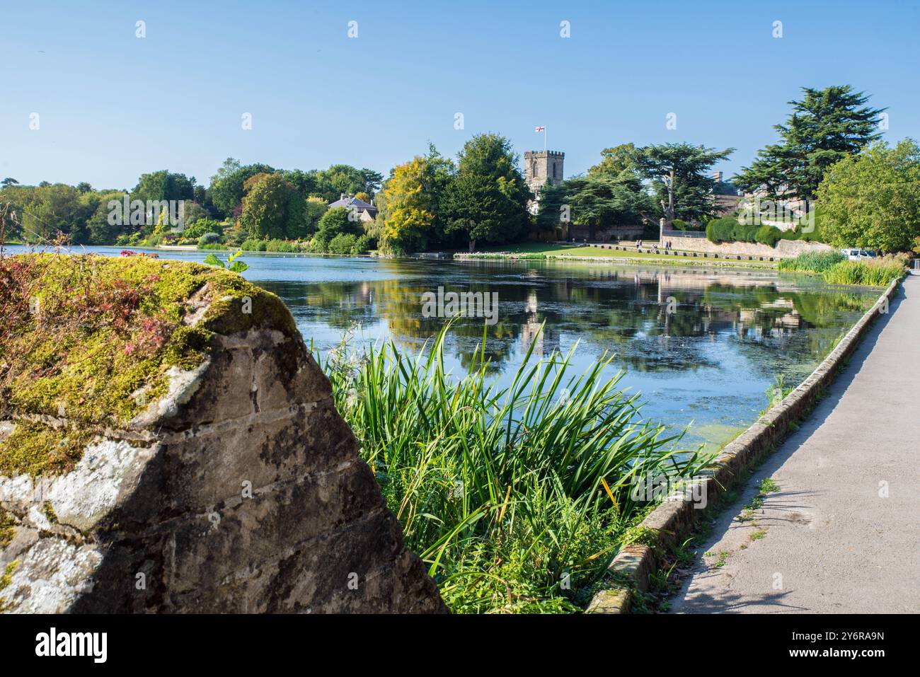 Melbourne Pool in Derbyshire, England with the church of Saint Michael ...
