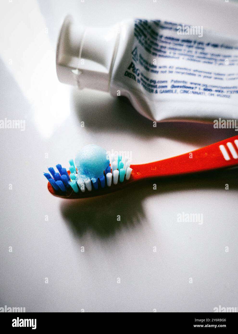 Still life of a tube of Crest, toothpaste and bristle toothbrush ready ...