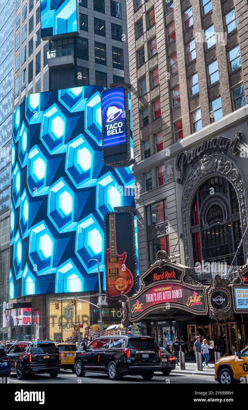 Street scene of Times Square includes restaurant signage and electronic ...
