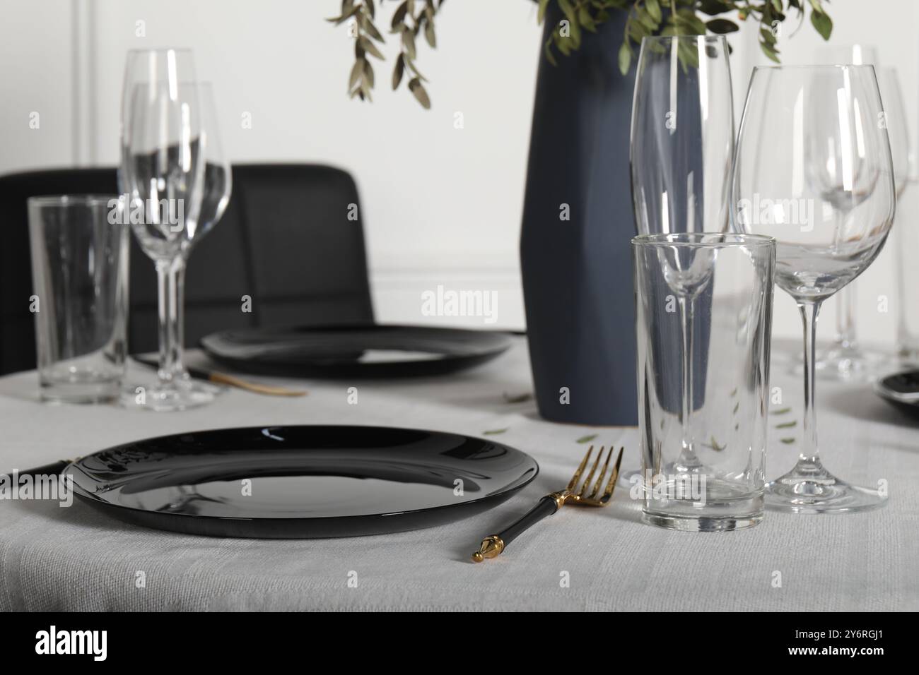 Stylish table setting with black dishware in dining room Stock Photo ...