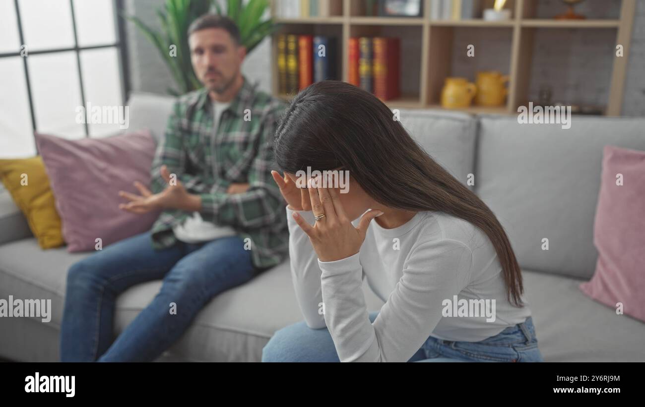 Upset woman covering face with hand while man gestures with concern in ...
