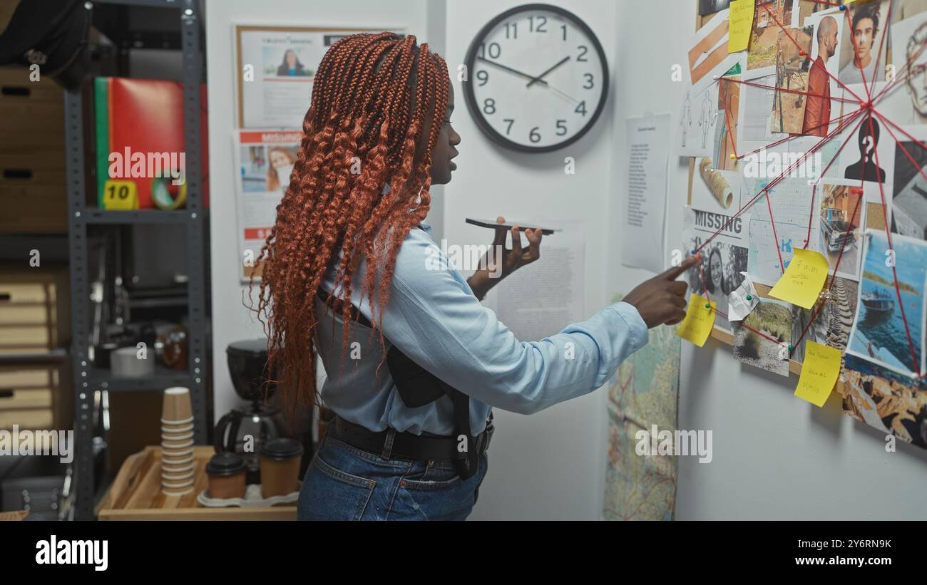 An african american woman detective examines evidence in a police ...