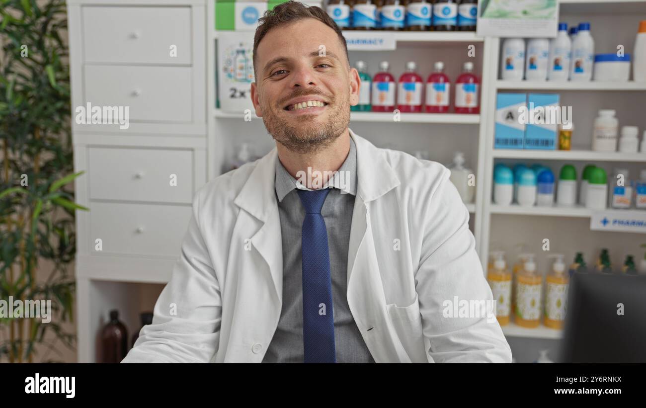 Smiling pharmacist man in white coat at pharmacy with shelves of ...
