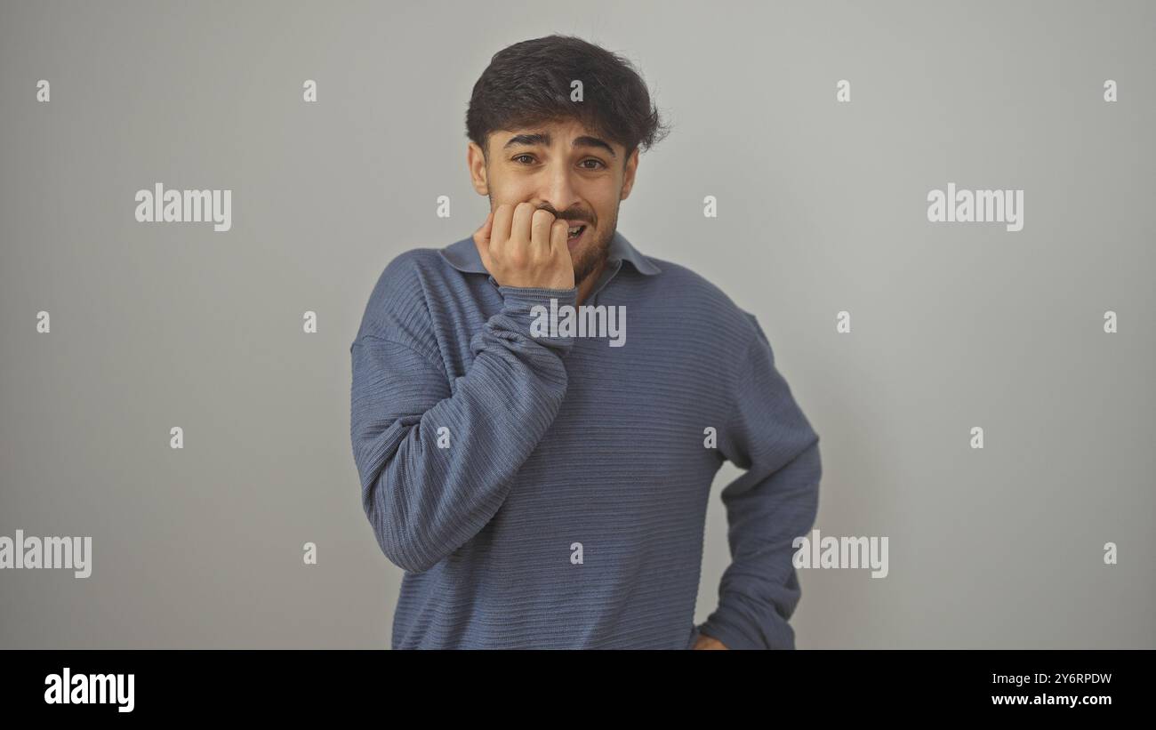 Handsome young man with beard appearing anxious isolated against a ...