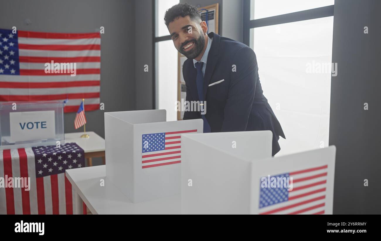 Handsome hispanic man smiling in a voting room with american flags and ...