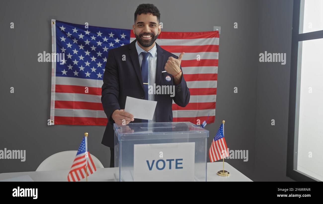 A smiling young hispanic man with a beard giving thumbs up after voting ...