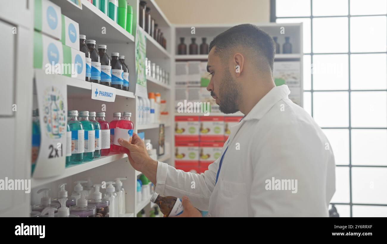 Hispanic pharmacist selects medication on shelves inside a bright ...