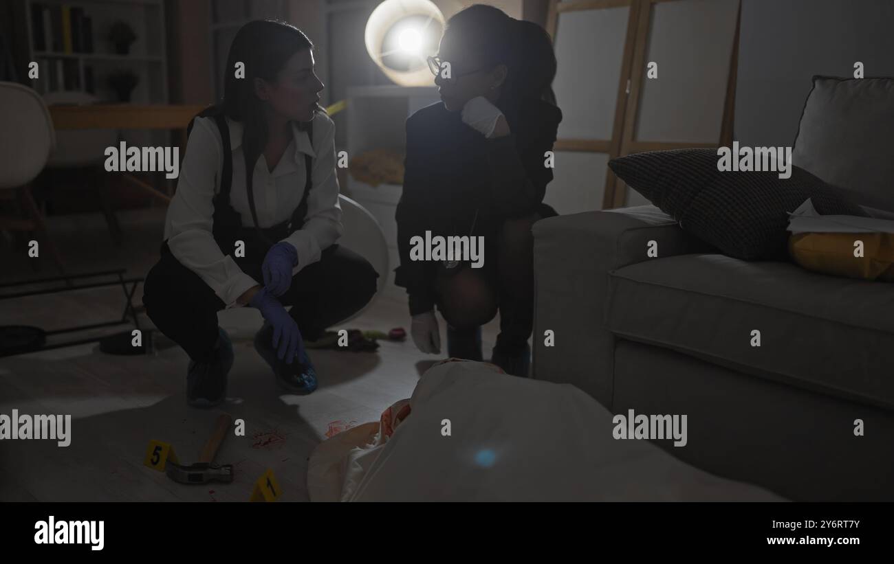Two women detectives in an indoor crime scene investigating a mock ...
