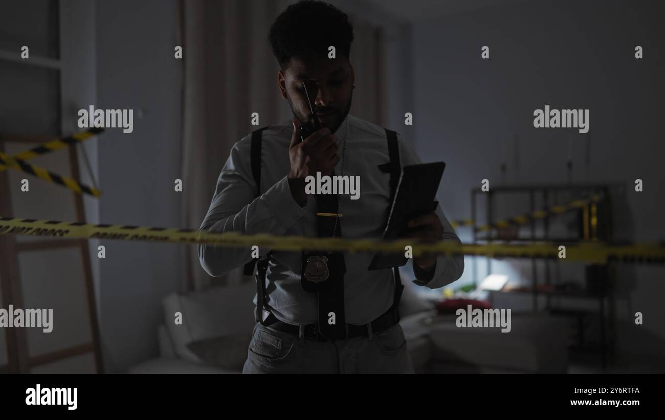 An african american police detective talks via walkie-talkie and ...