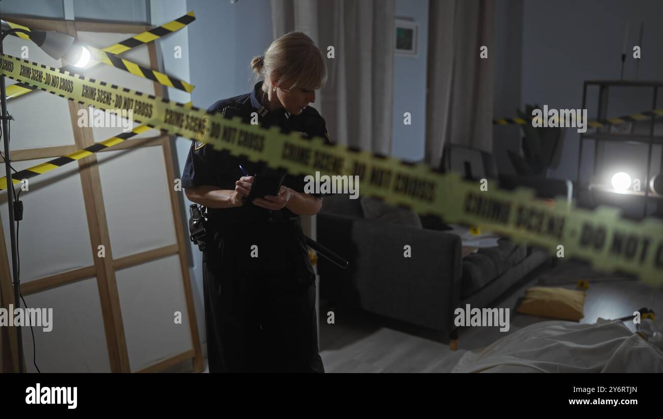 Blonde police officer takes notes at indoor crime scene with caution ...