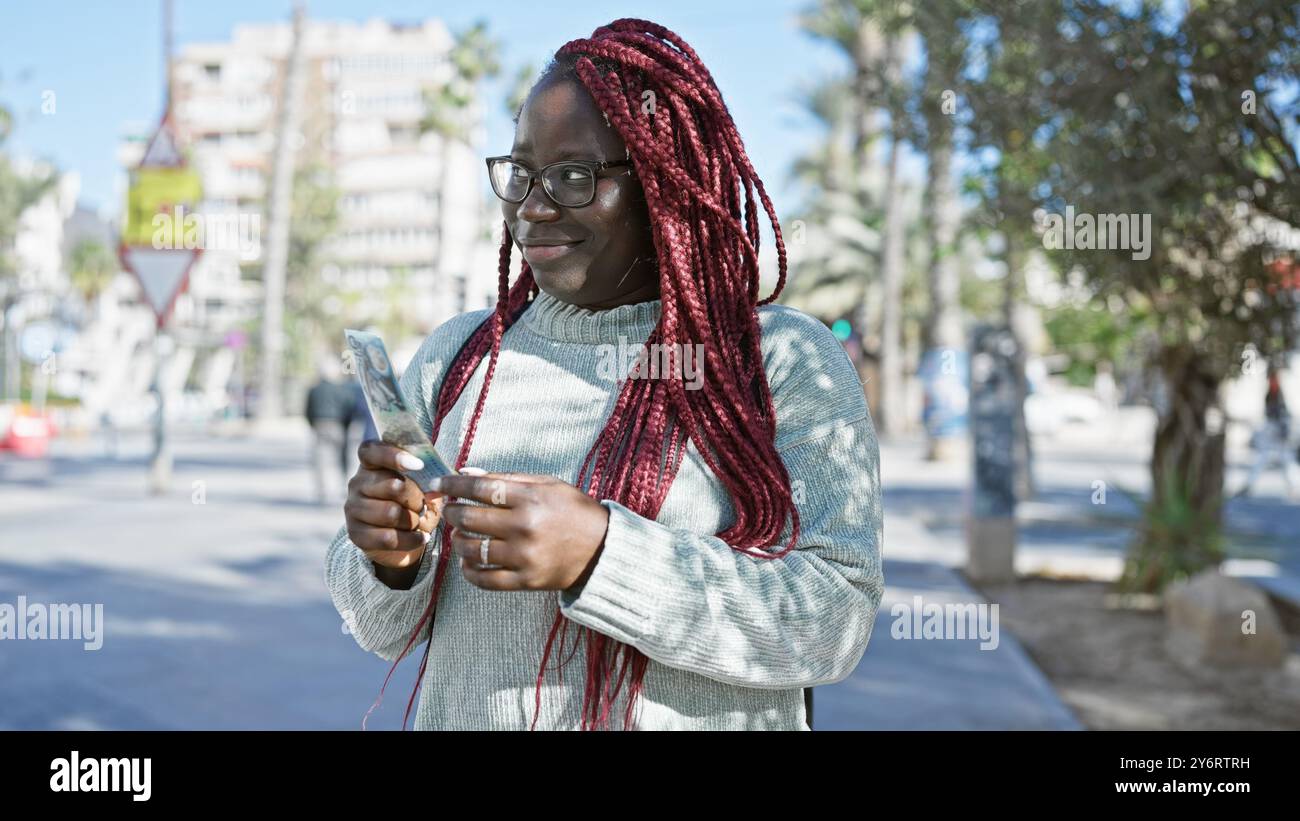 African woman braids counting dollars hi-res stock photography and ...