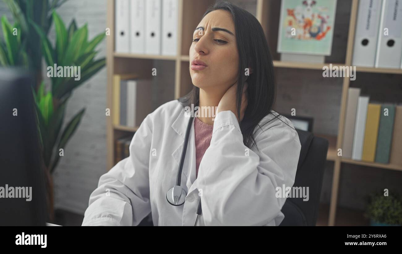 A young hispanic woman doctor feeling neck pain in a clinic office ...