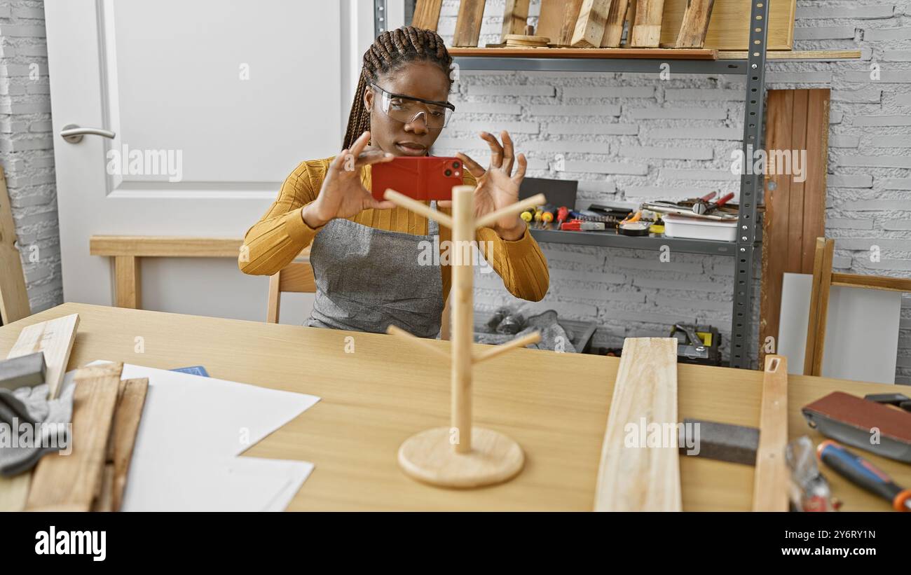African american woman with braids photographing wooden structure at ...