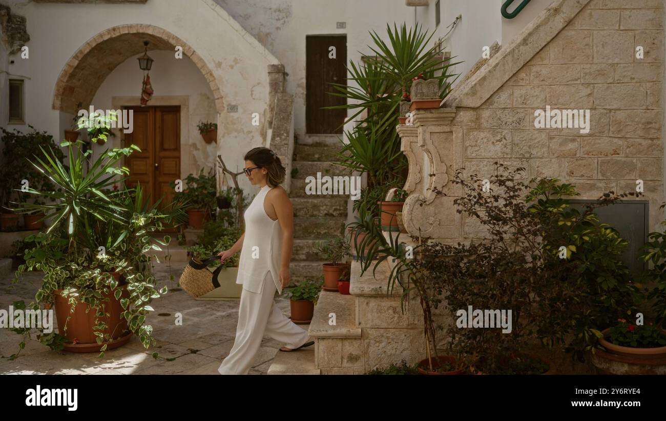 A beautiful young hispanic woman strolling through the charming old ...