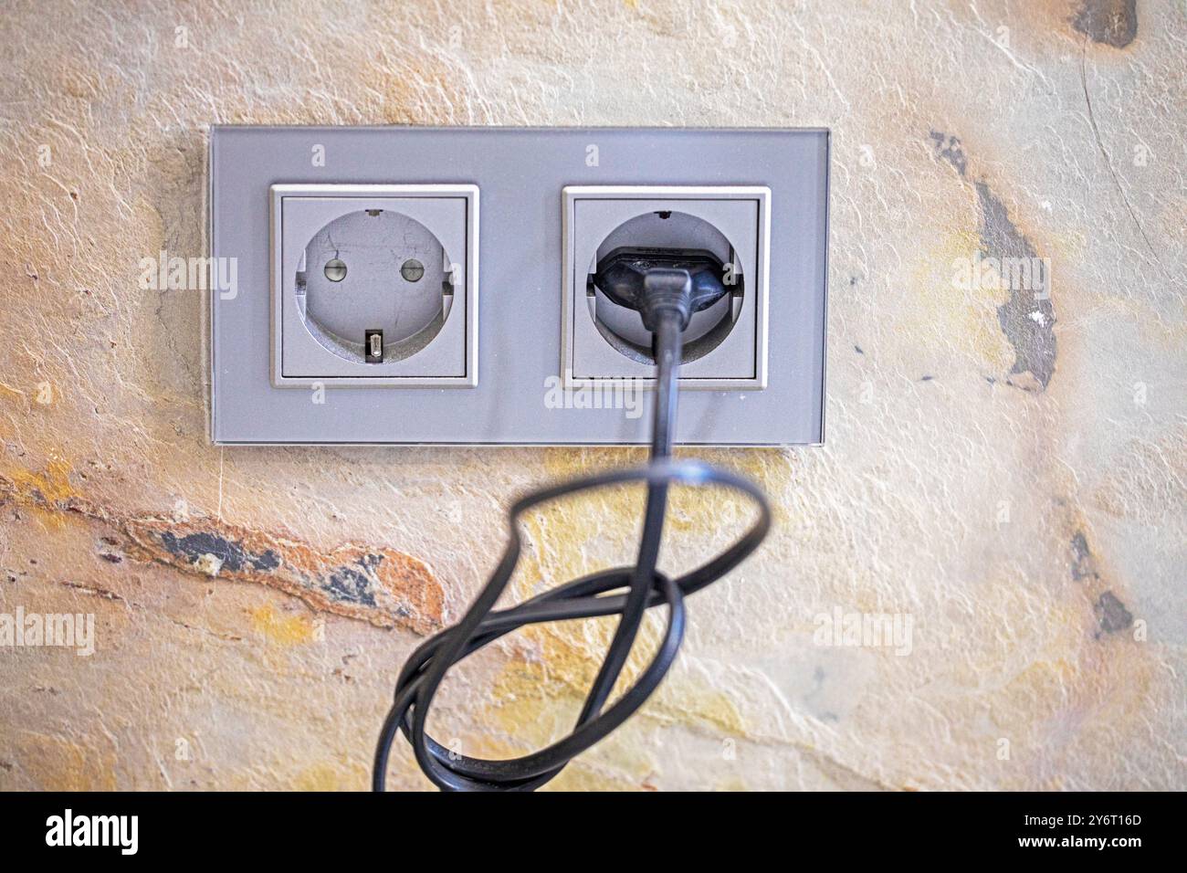 modern sockets in the interior on a concrete wall Stock Photo - Alamy